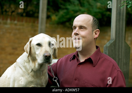 Blind man looking happy with golden labrador guide dog Stock Photo - Alamy