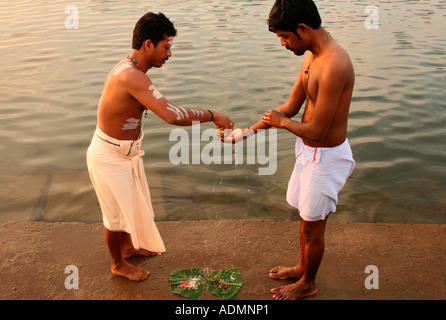 Hindu man performing pooja at the banks of the Periyar river. The ...