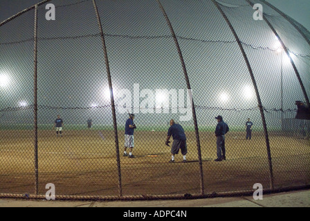 Mens softball team playing on a foggy night Stock Photo - Alamy