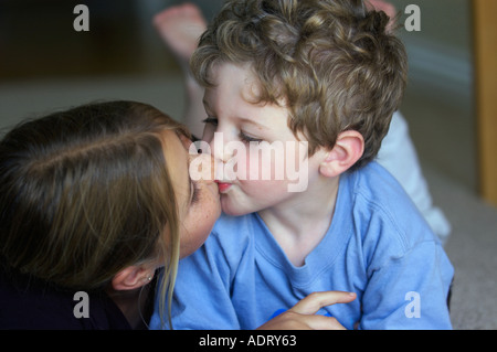 young brother giving sister a kiss Stock Photo: 5376166 - Alamy