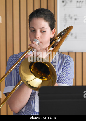 High school girl playing trombone in class, side view Stock Photo ...