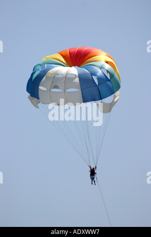 Towed parachute ride behind a speedboat over the sea at Palma Nova in ...