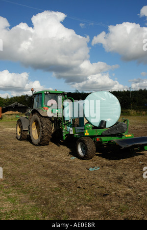 Wrapping round bales of hay for Haylage Stock Photo - Alamy