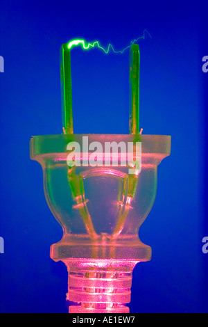 Electric Plug with sparks between the prongs against an orange ...