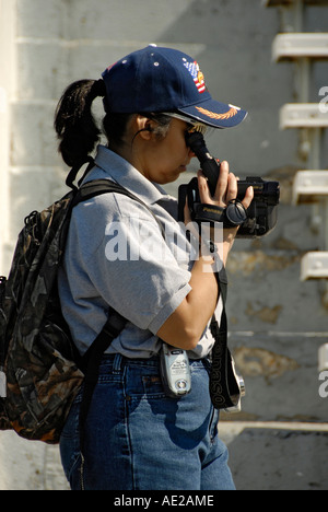 Female uses video camera to record and event Stock Photo - Alamy