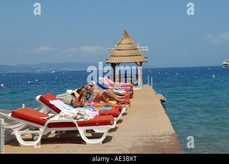Sunbathers on beach on French Riviera France Stock Photo - Alamy
