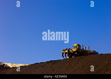 Slag dump slope stabilizing operation with truck being loaded, Greater ...