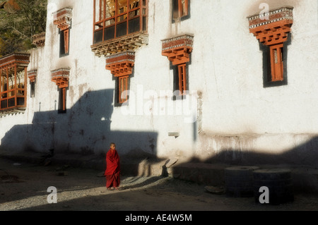 Buddhist monk walking past Hemis gompa (monastery), Hemis, Ladakh ...