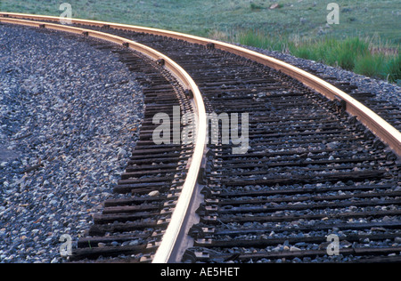 Railroad tracks curving into bend into distance Stock Photo - Alamy