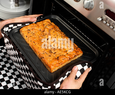Italian food: man baking bread in traditional oven very common in small ...