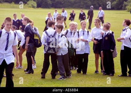 Secondary school children walking in park Stock Photo - Alamy