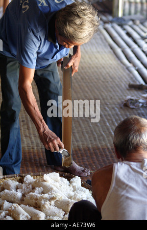 Elderly Man Scraping Roasted Glutinous Rice From Bamboo, Kamung Annah ...