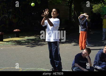 Primary school child catching ball Stock Photo - Alamy
