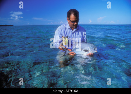 Man holding permit fish caught while fly fishing in southern Belize ...