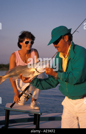 Florida couple fishing for redfish red drum guide holding up redfish ...