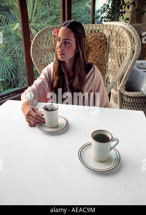 A young woman drinks a coffee in a coffee shop Stock Photo - Alamy