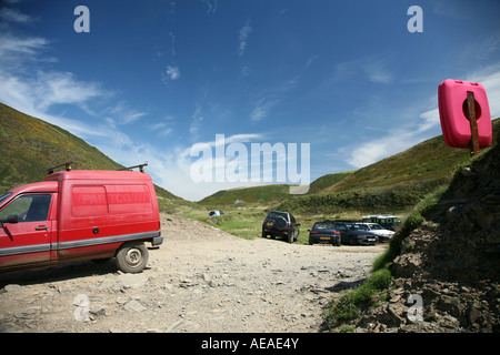 welcome bay in devon with a bright red van parked Stock Photo - Alamy