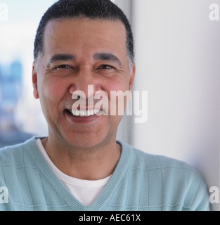 close up view of smiling african american curly girl laying in bed with ...