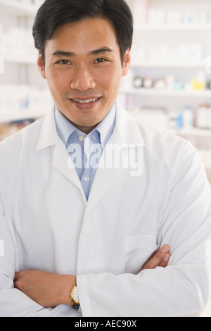 Chinese young man working at pharmacy drugstore with hand on head ...