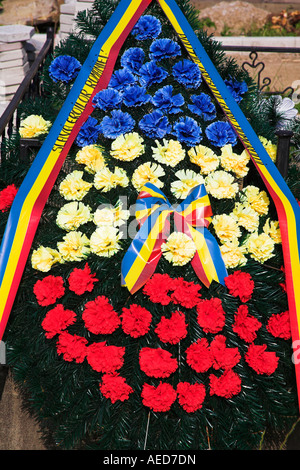 A floral wreath in the national colours of the Ukraine lie on top of ...