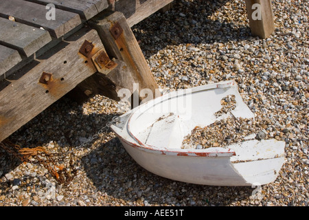 Half of an old boat tethered to a pier and smashed apart by the sea ...
