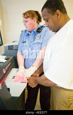 Inmate getting fingerprints digitally scanned. Diagnostic and ...