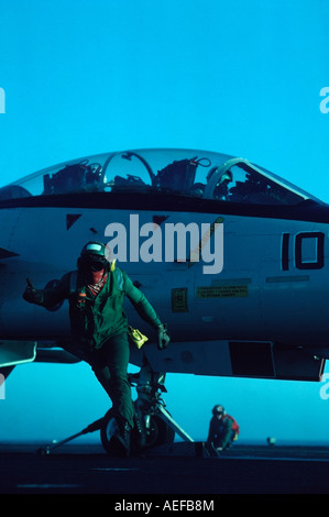 US Navy A flight deck crewman gives the thumbs up signal to launch ...