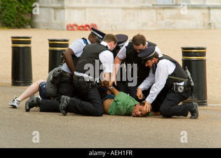 Horizontal close up of a man resisting arrest and struggling with a ...
