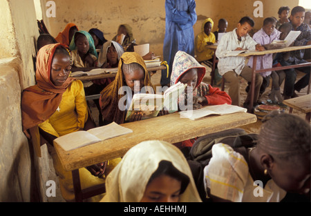 Group of primary school students sitting at their desks in a bright ...