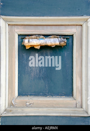 Newspaper in newspaper slot in door Stock Photo - Alamy