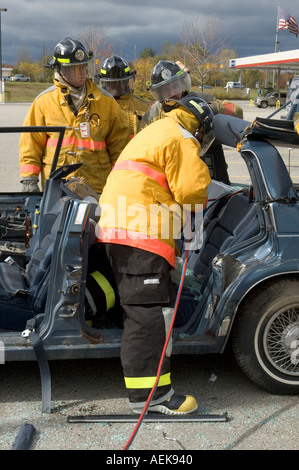 Fireman works with the jaws of life to extract victim from automobile ...