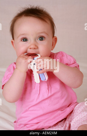 adorable baby girl teething and chewing teethers Stock Photo - Alamy