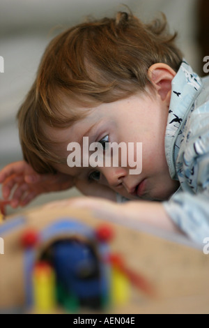 Lewis and his wooden train set Stock Photo - Alamy