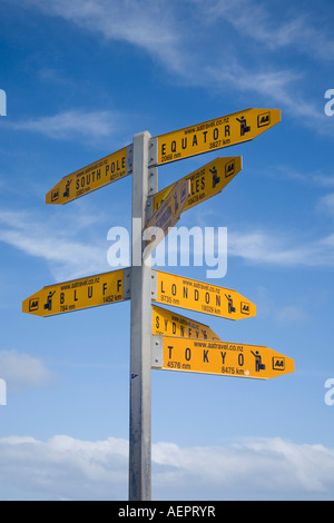 Yellow signs, signpost with different destinations, cities and ...