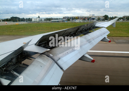 Jet plane air brakes and flaps fully extended after landing. Hydraulic ...
