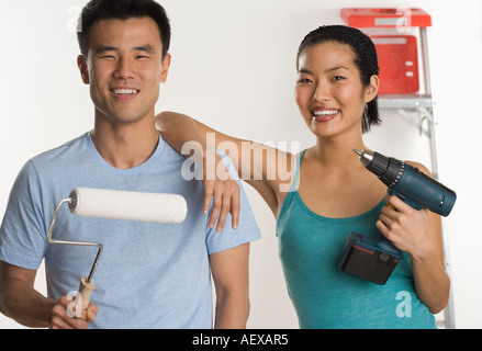 Portrait of couple doing home repairs Stock Photo - Alamy