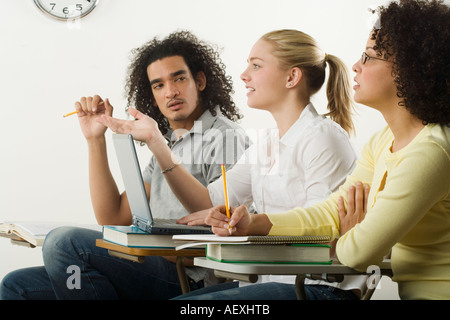 Three college students in class Stock Photo - Alamy