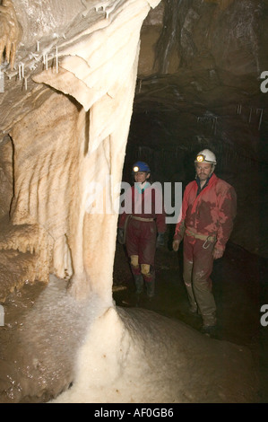 male and female cavers in Notts II cave admire formations in a stream ...