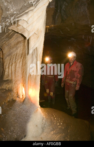 male and female cavers in Notts II cave admire formations in a stream ...