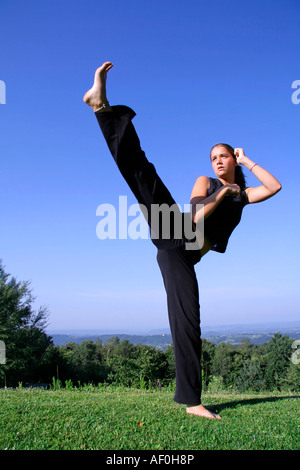 high split kick attractive young woman practising self defense Stock ...