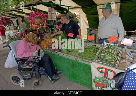 Woman in a wheelchair shopping for vegetables in a supermarket Stock ...