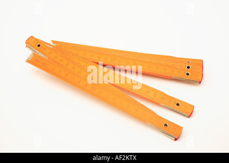 a yellow metre rule on a white surface meter Stock Photo - Alamy