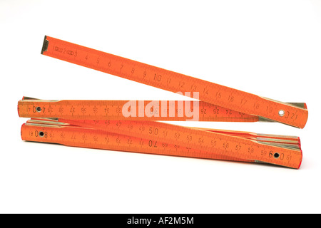 a yellow metre rule on a white surface Stock Photo - Alamy