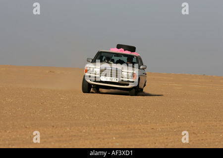 a mercedes 230e crossing the sahara desert Stock Photo - Alamy