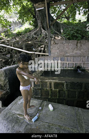 HONDURAS TEGUCIGALPA Young Honduran girl bathing in public washing site ...