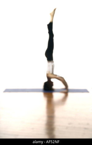 Side profile of a woman doing headstand Stock Photo - Alamy