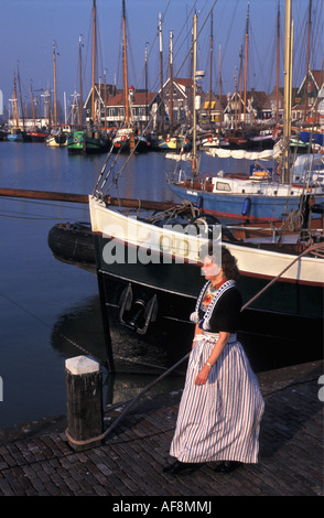 Woman in traditional Volendam dress drinking cup of tea, 1898 line ...