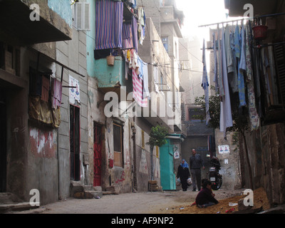 Egypt, Cairo. Everyday poverty in downtown Cairo, local man digging in ...
