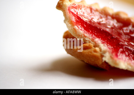 Half eaten jam tart Stock Photo - Alamy