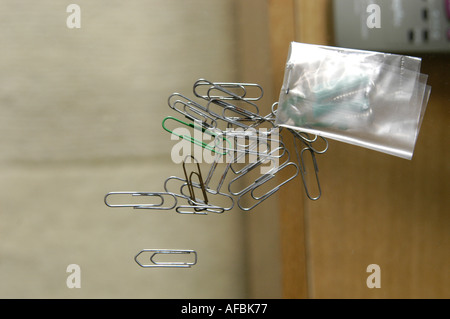 stainless steel paper clips on a glass table with plastic bag Stock ...